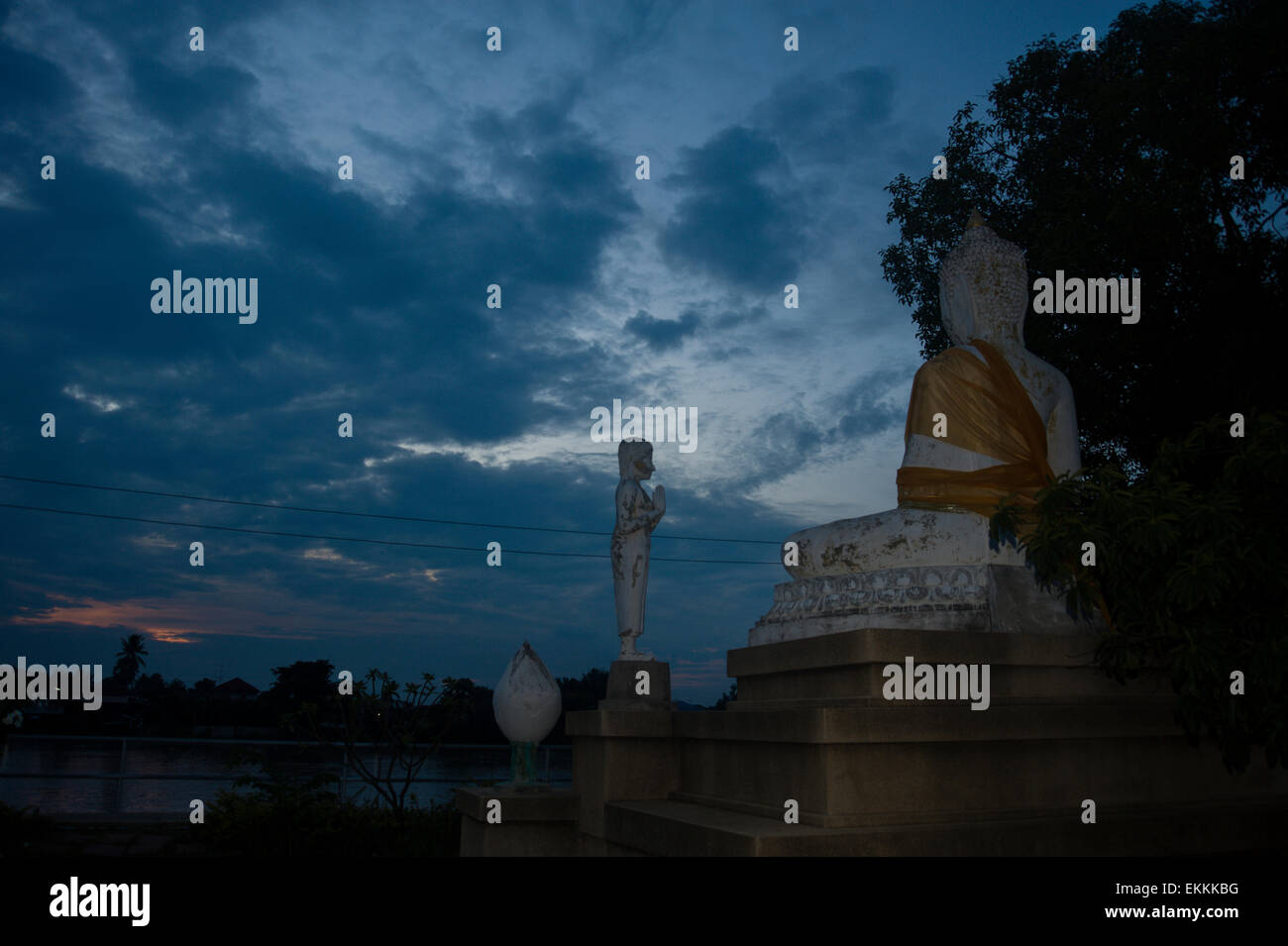 A Statue of a Buddhist Monk and Buddha with the sunset Stock Photo - Alamy