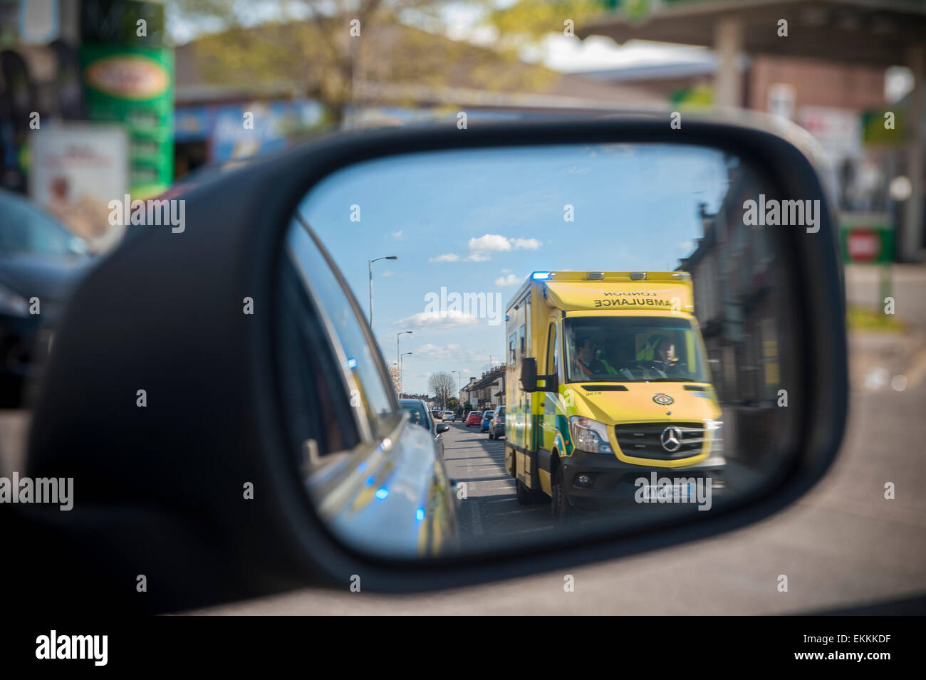 An racing ambulance with flashing lights overtakes a car which sees it ...