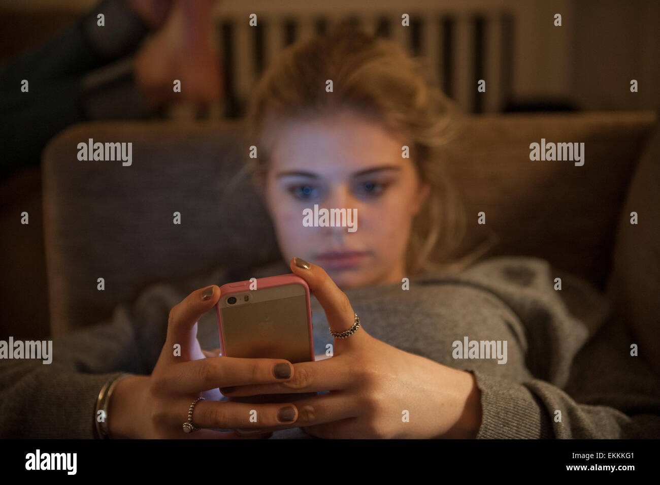 A teenage girl plays on her mobile cell phone Stock Photo - Alamy