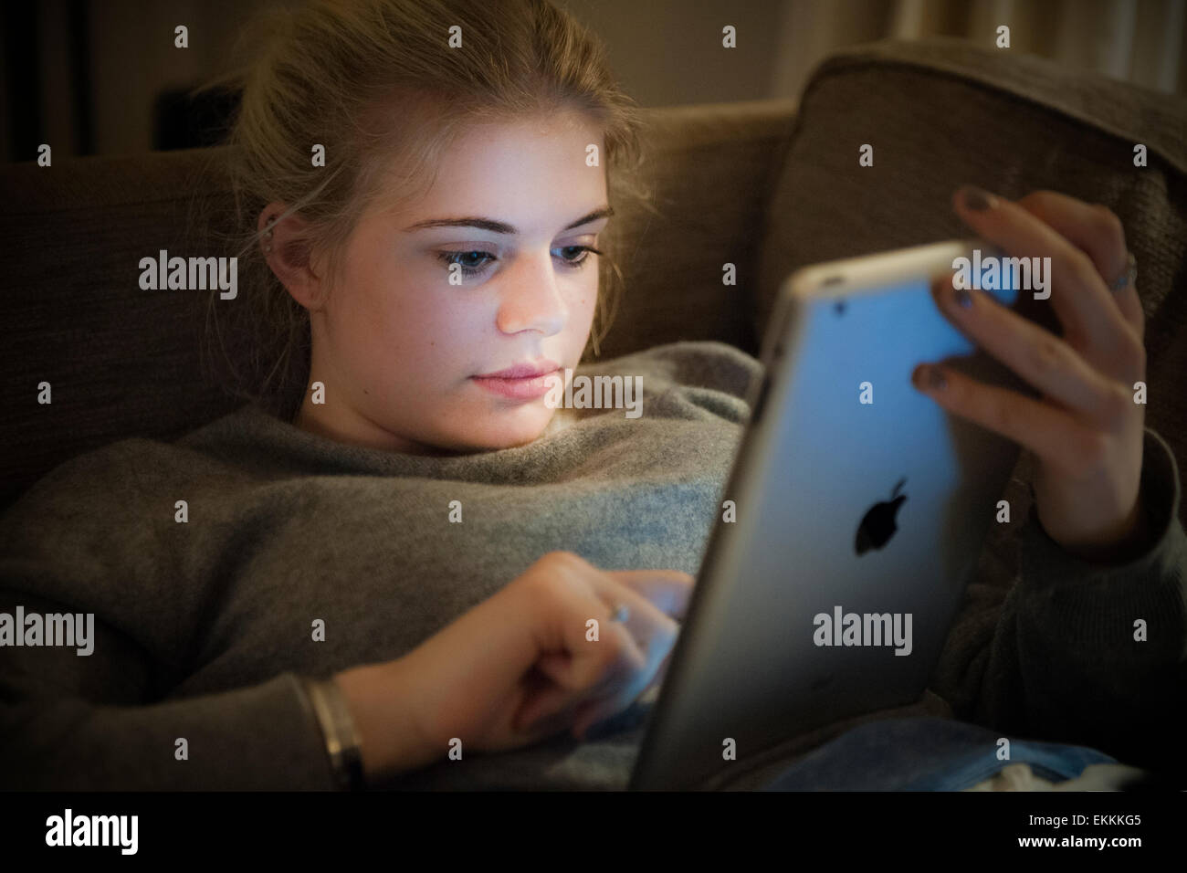 A teenage girl plays on her ipad tablet Stock Photo - Alamy