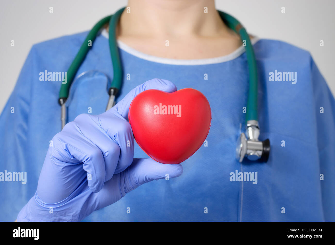Red heart in the hand of a doctor Stock Photo - Alamy