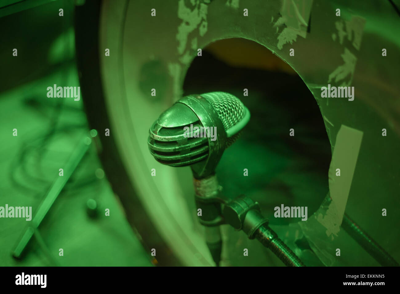 Old Bass drum microphone on green stage lighting Stock Photo - Alamy