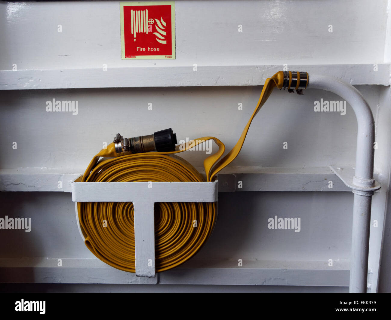 A coiled hose pipe and fire fighting nozel in a basket onboard a ...