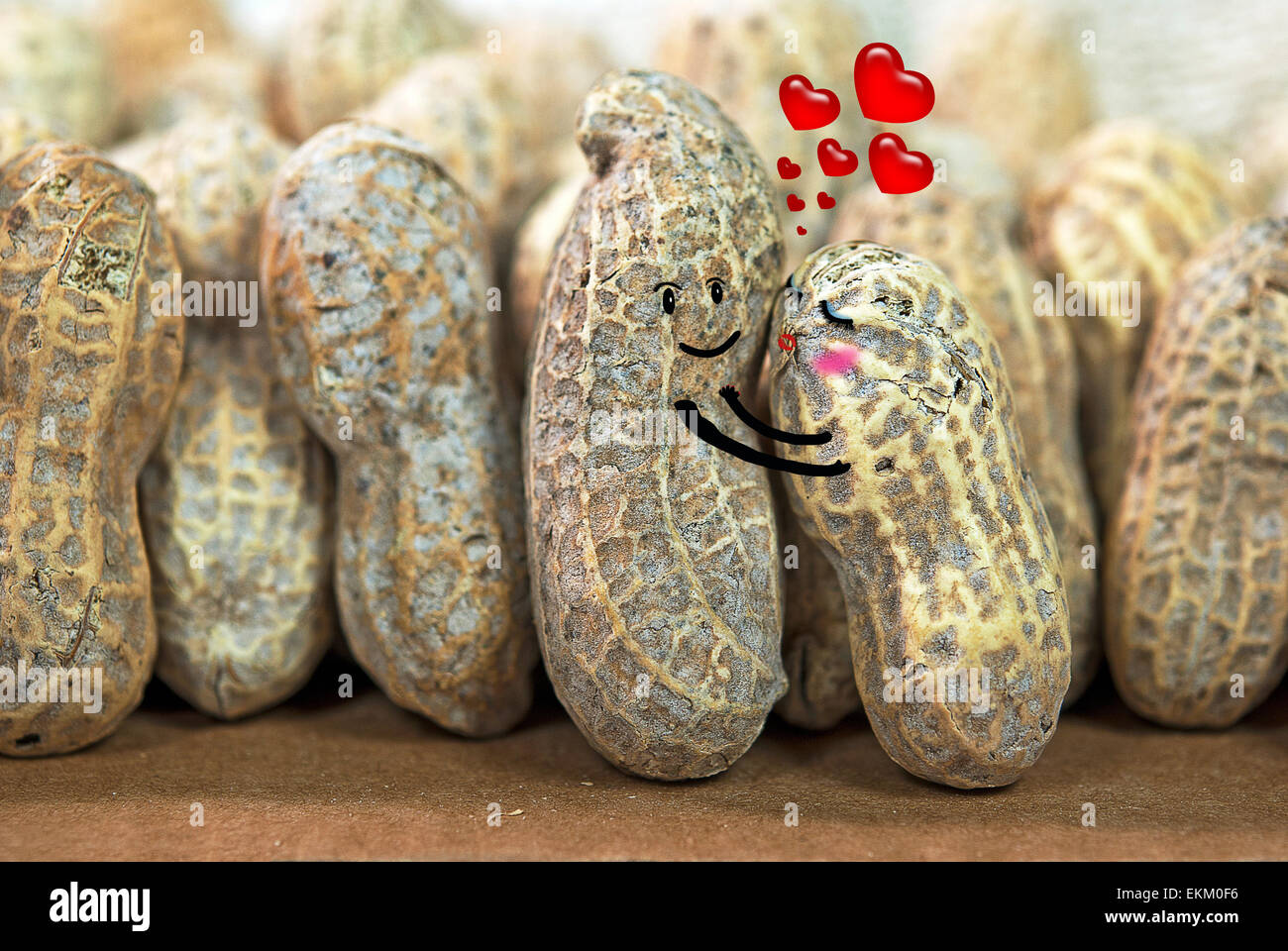 Pair of peanuts hugging in a crowd of peanuts Stock Photo - Alamy