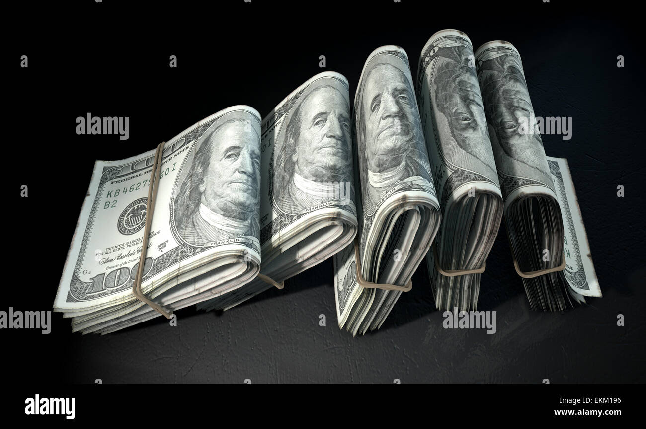 A close-up view of five wads of folded over stacks of us dollar ...