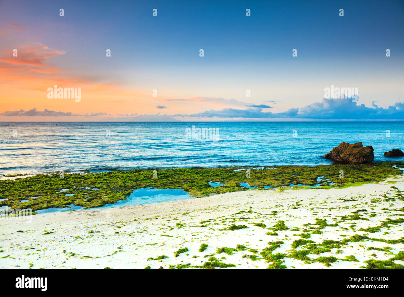 Sunrise over the sea. Stone on the foreground Stock Photo - Alamy