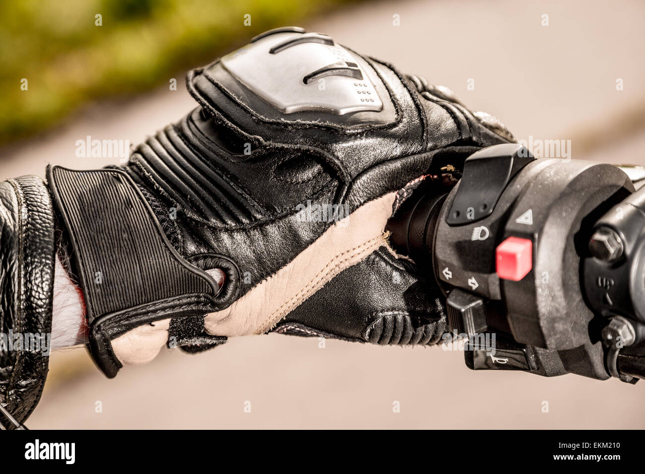 Human hand in a Motorcycle Racing Gloves holds a motorcycle throttle ...