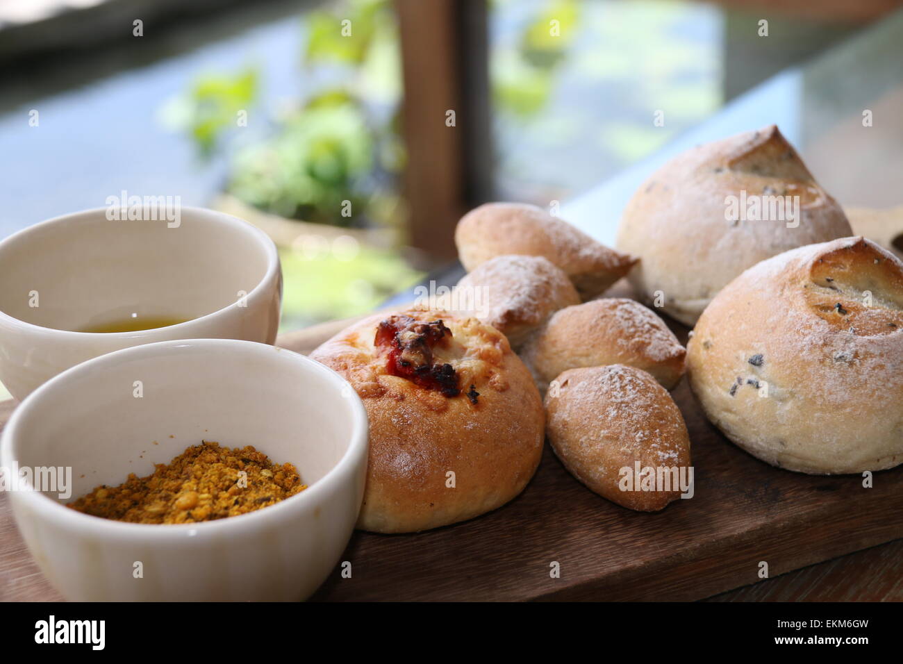 Assortment of artisanal bread rolls and the condiments Stock Photo - Alamy