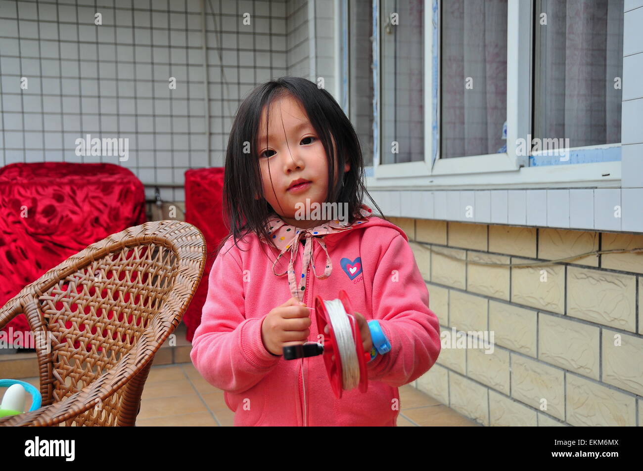 Pengzhou, China: Three year old little Chinese girl playing with a ...