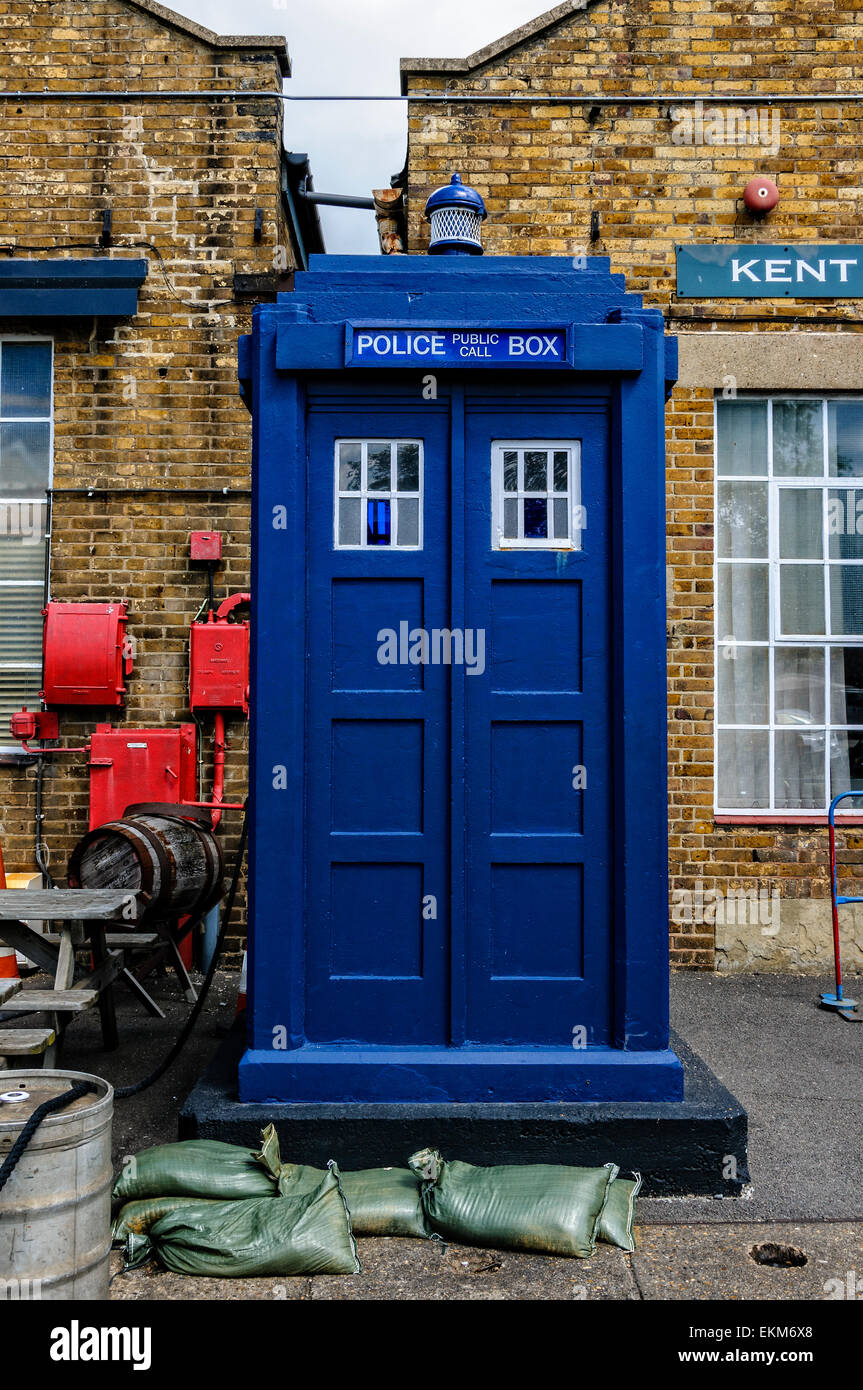 An old fashioned rectangular blue police box standing in front of the ...