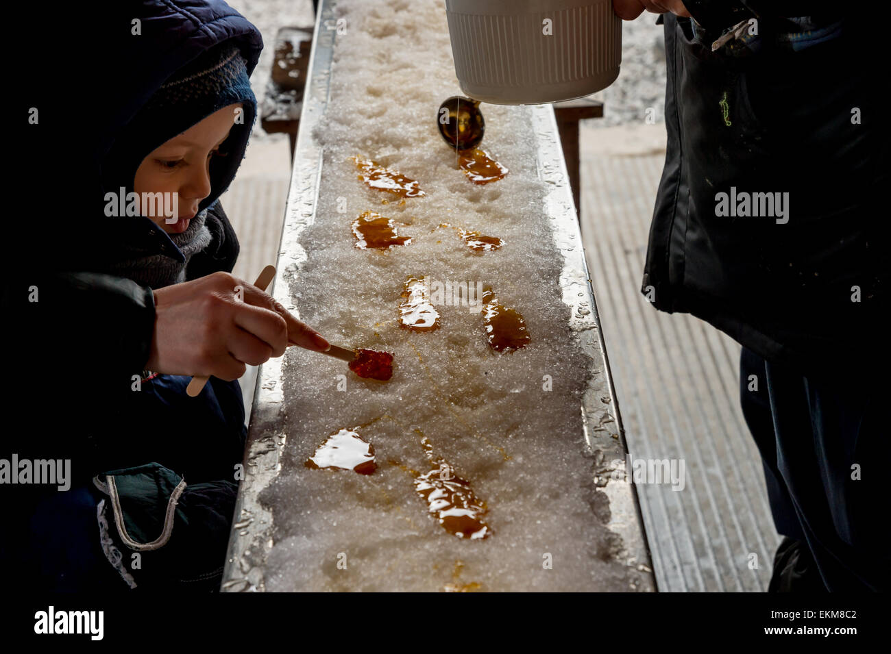 Maple taffy on snow during sugar shack period. In Quebec, Canada Stock ...