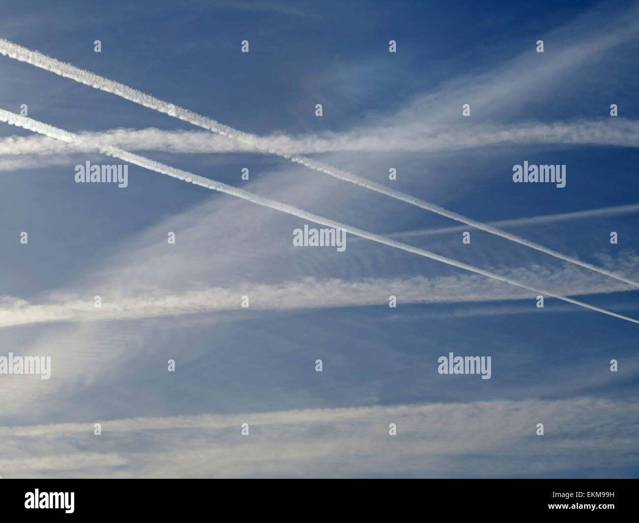 Jet contrails / vapour trails against a blue sky Stock Photo - Alamy