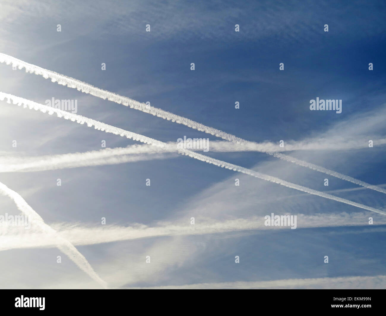 Jet contrails / vapour trails against a blue sky Stock Photo - Alamy