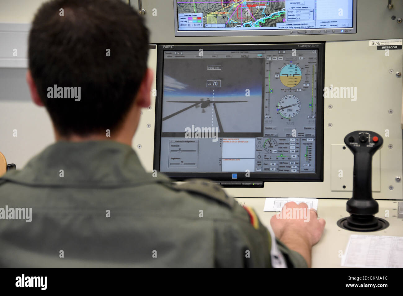 A former fighter pilot steers a drone with a joystick during training ...