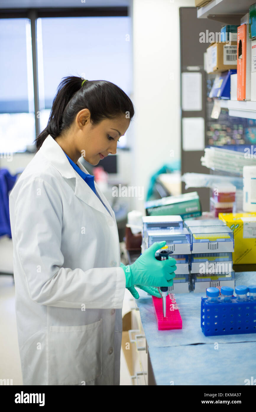 Closeup portrait, young scientist in labcoat doing experiments in lab ...