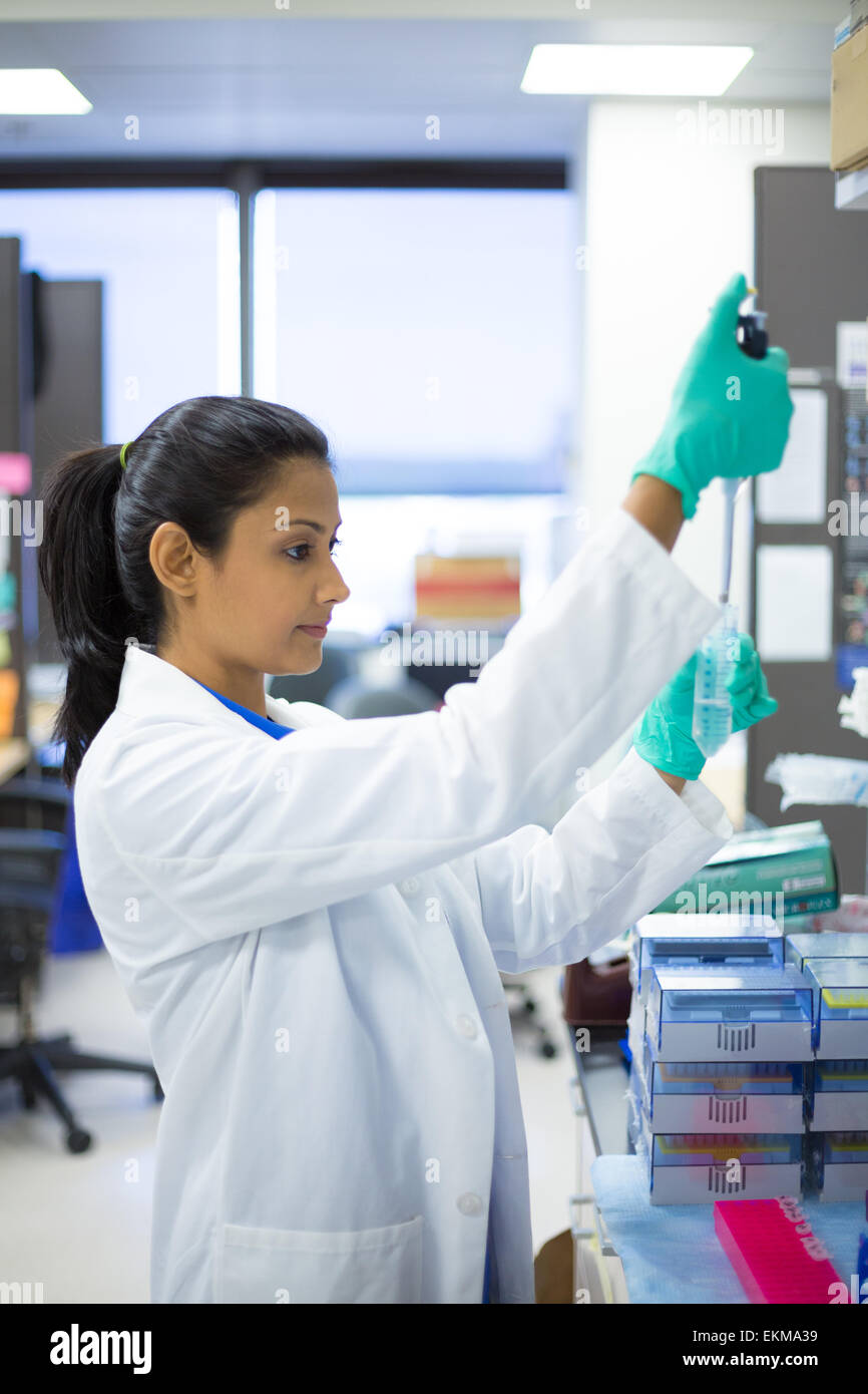 Closeup portrait, young scientist in white labcoat and blue nitrile ...