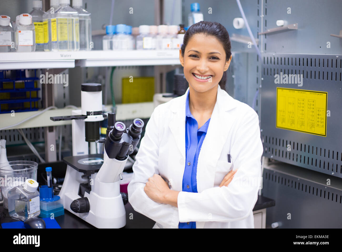 Closeup portrait, young smiling scientist in white lab coat standing by ...