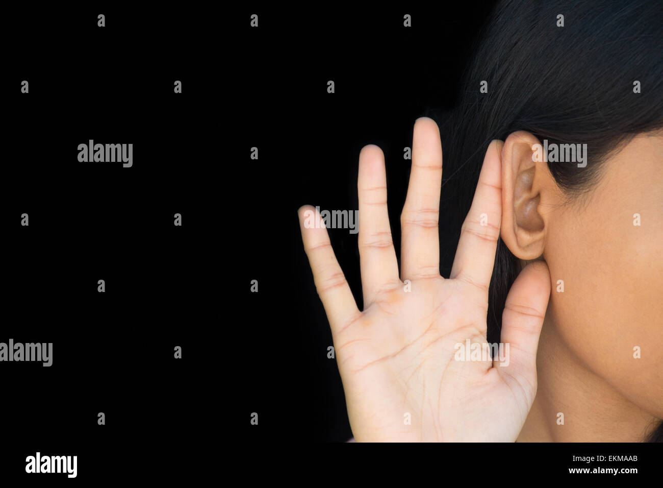 Closeup cropped portrait, half face with black hair, hand to ear ...