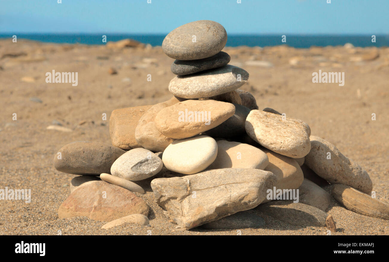 Stacked stones on Geropotamos beach with view on the Mediterranean Sea ...