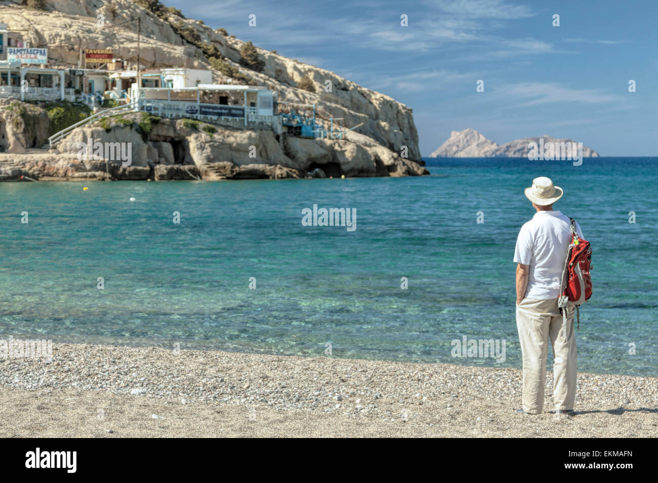 Tourist enjoying the stunning view on the beach at Matala, situated on ...