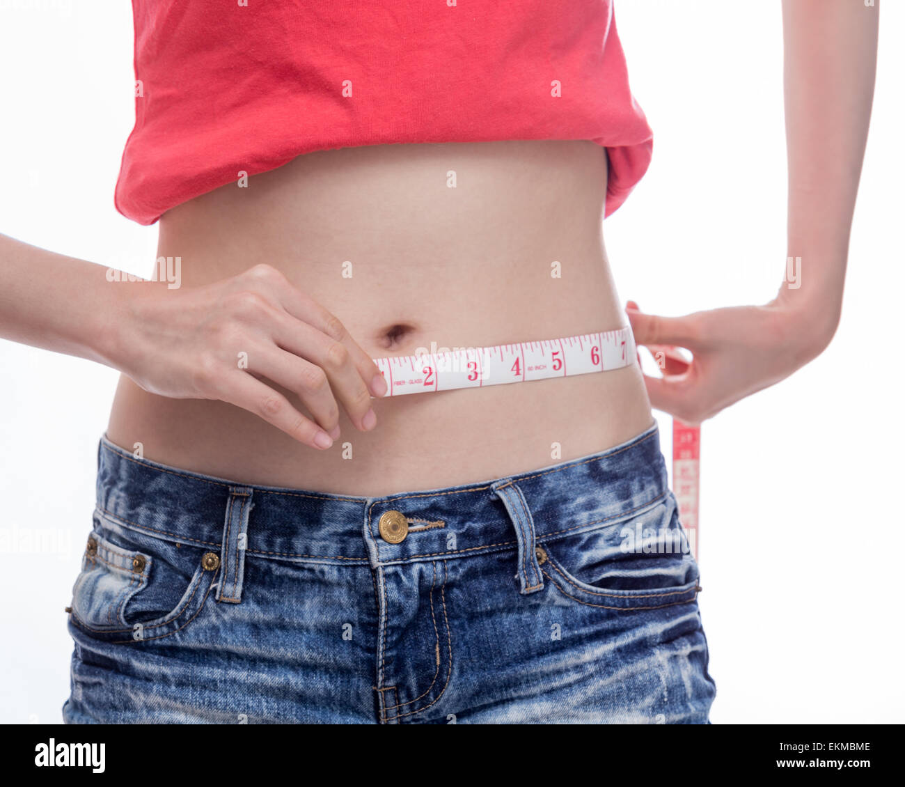 Woman checking stomach measurements with measuring tape Stock Photo - Alamy