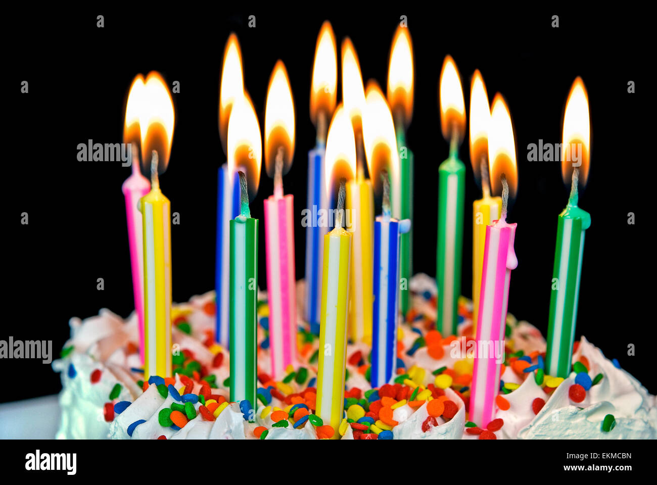 Many birthday candles on a cake with colorful sprinkles Stock Photo - Alamy