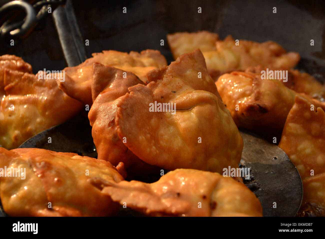 Deep fryed samosas right from hot oil or pan Stock Photo - Alamy