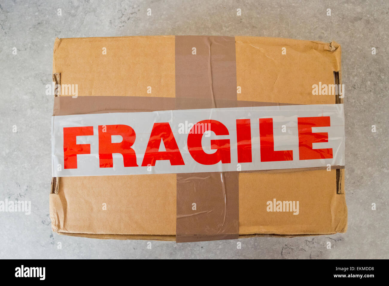 Cardboard Box Parcel With Fragile Packing Tape Stock Photo - Alamy