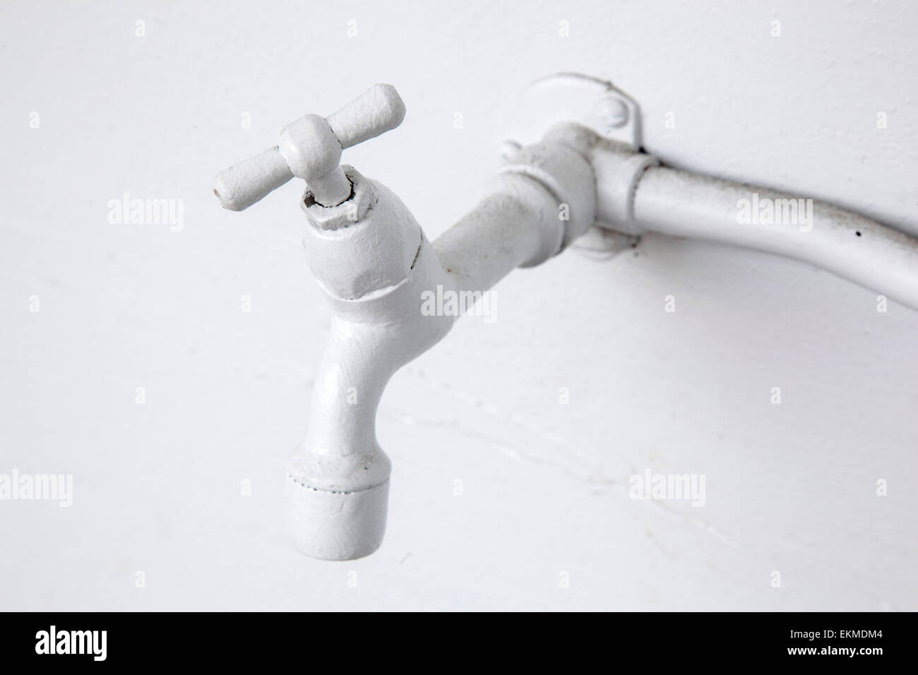 white painted water tap against white washed wall Stock Photo - Alamy