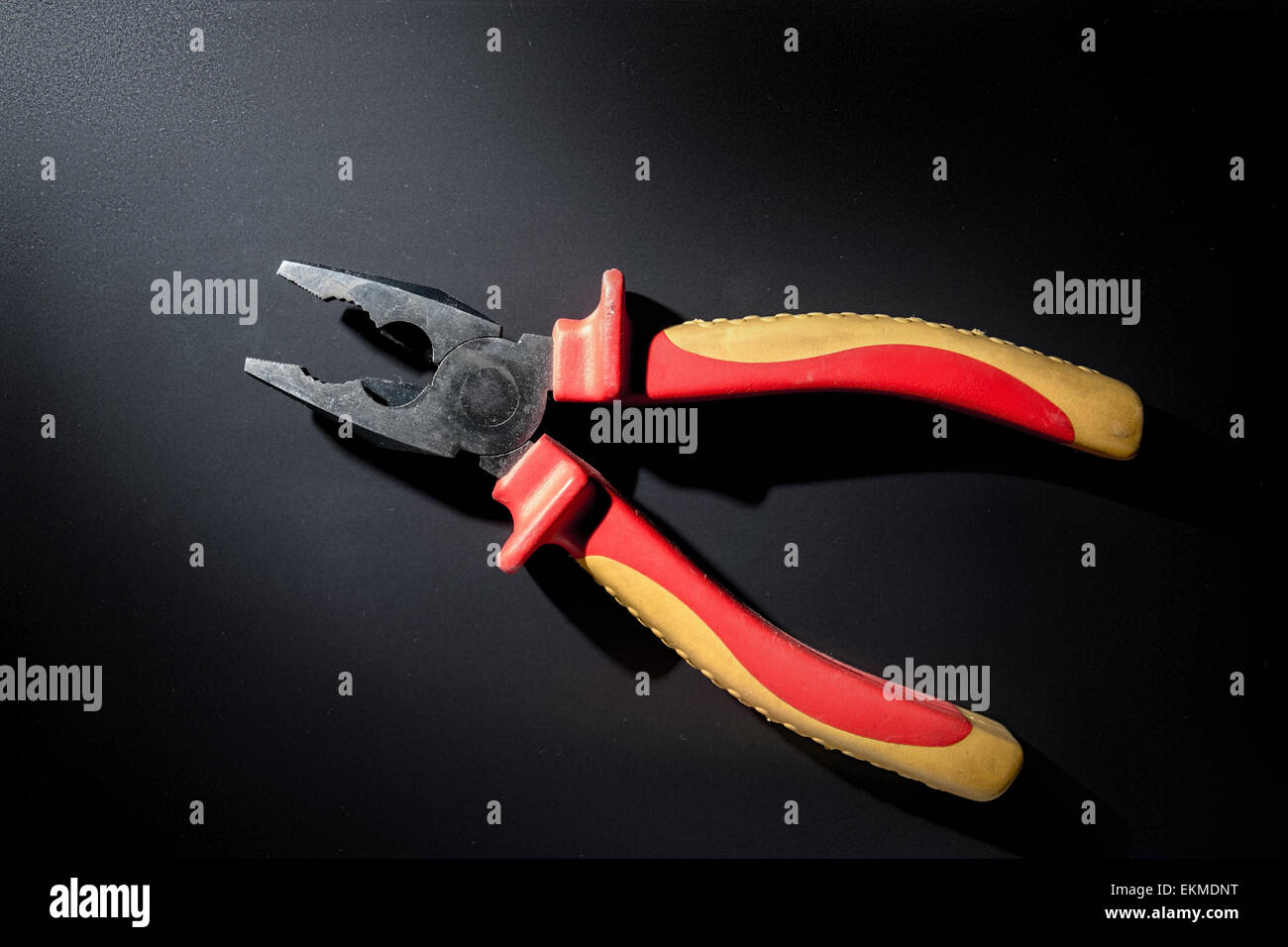 Indastrial tool - high voltage pliers on dark background with heavy ...