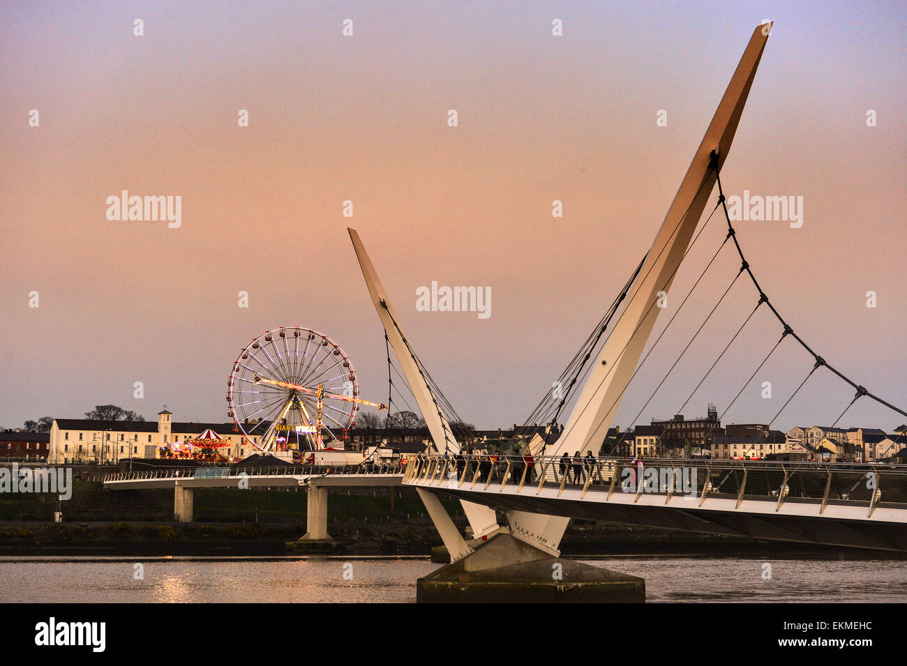 Peace Bridge at dusk with Ferris wheel in background, Derry ...