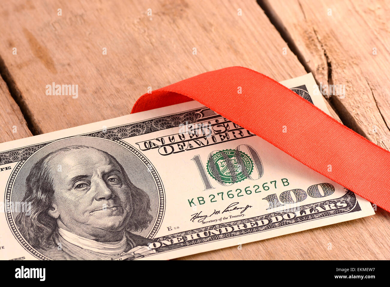One Hundred Dollar Bills Wrapper in Red Ribbon Stock Photo - Alamy