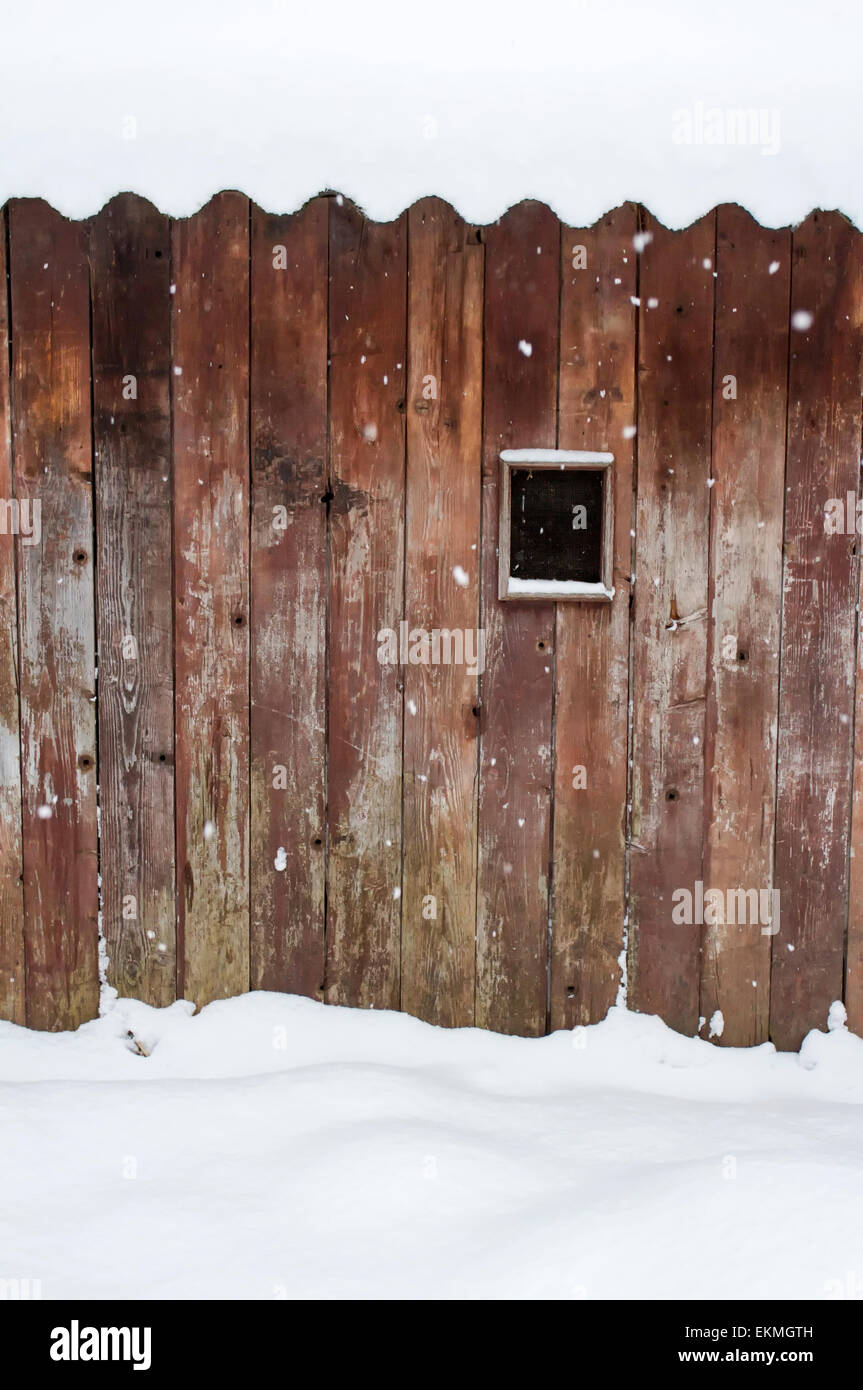 Detail of the old wooden hut with small window, covered with snow Stock ...