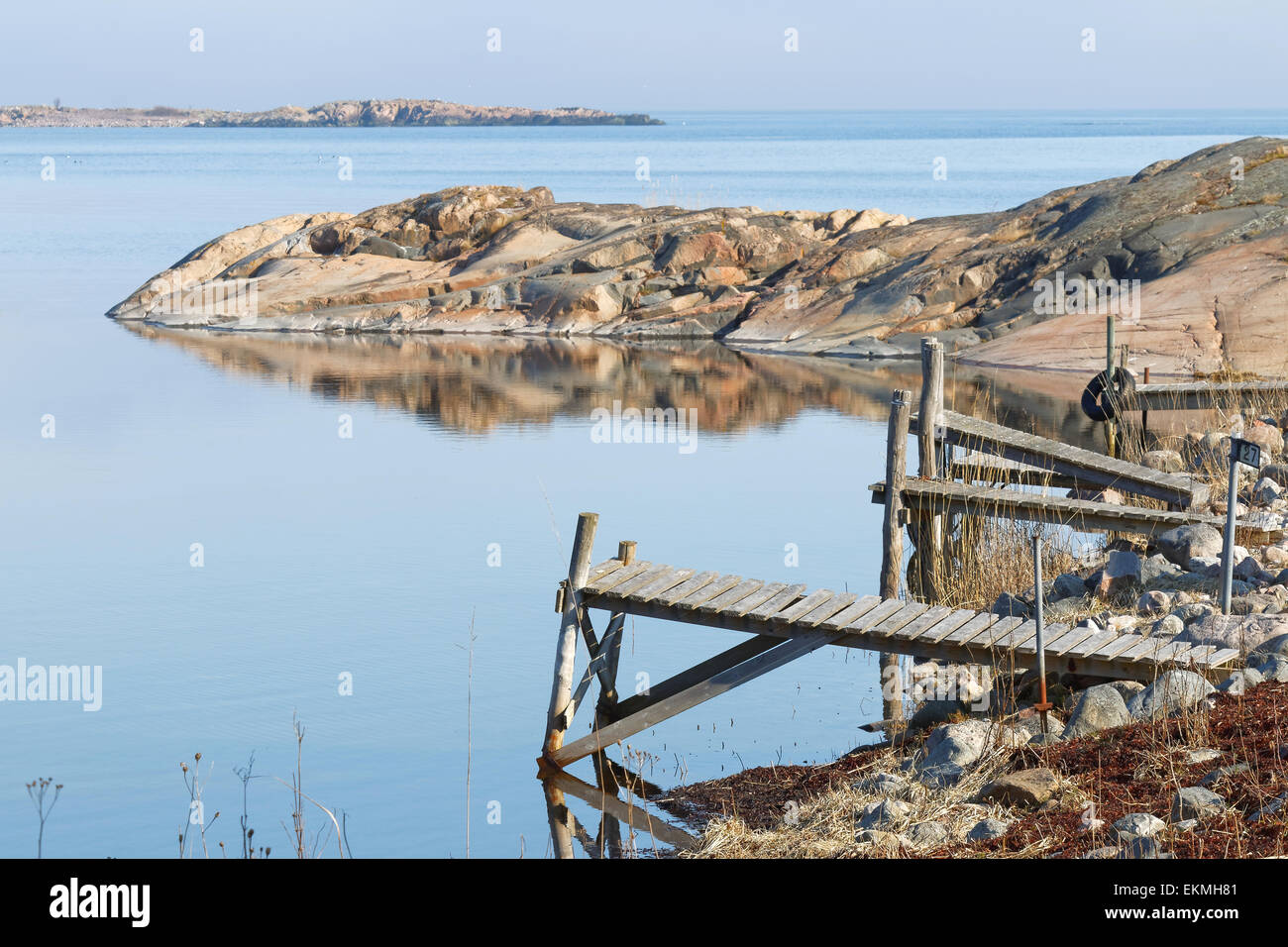 Silhouette of many tiny wooden bridges and calm blue water in a ...