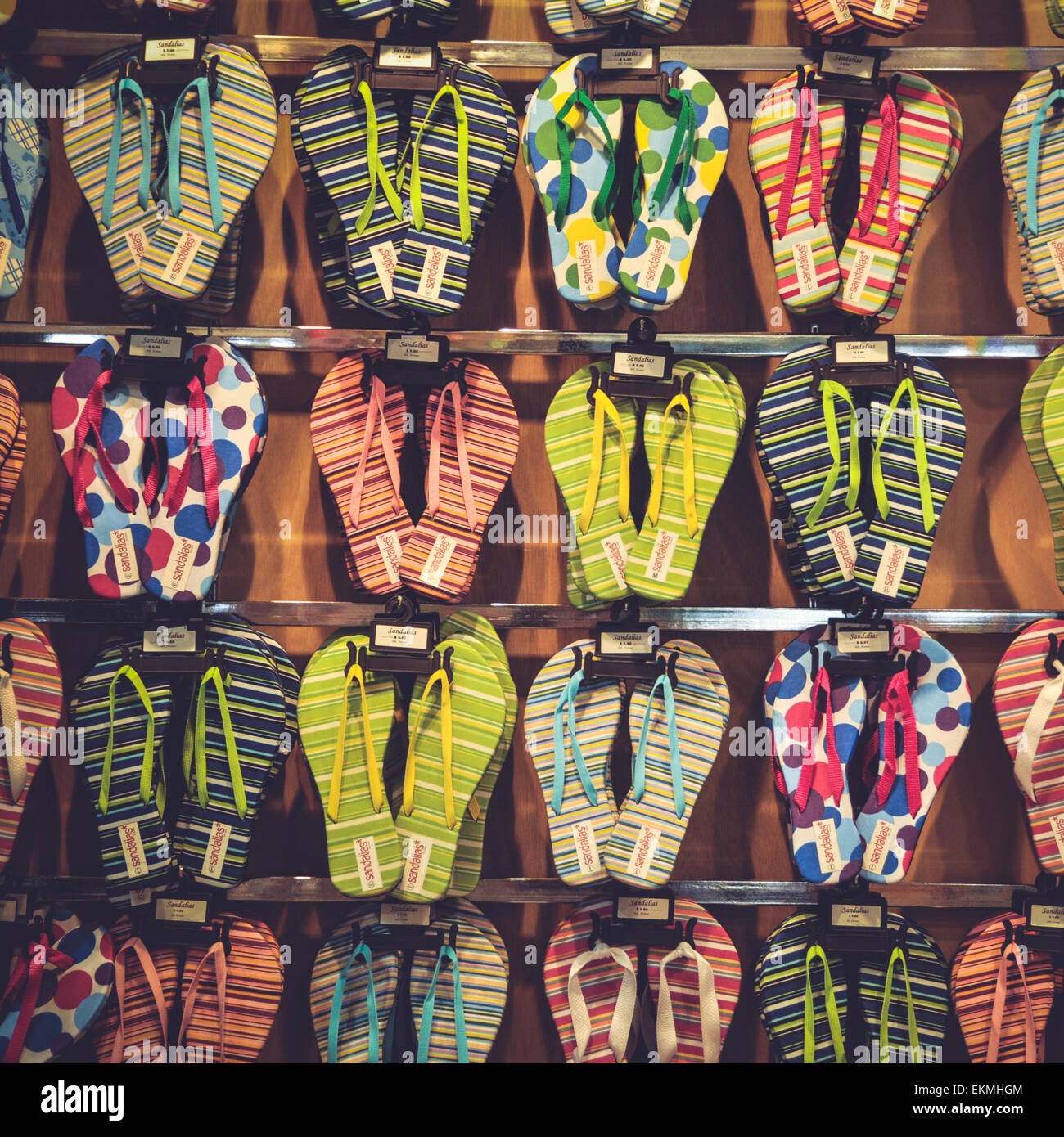 Summer flip-flops for sale hanging in shop Stock Photo - Alamy