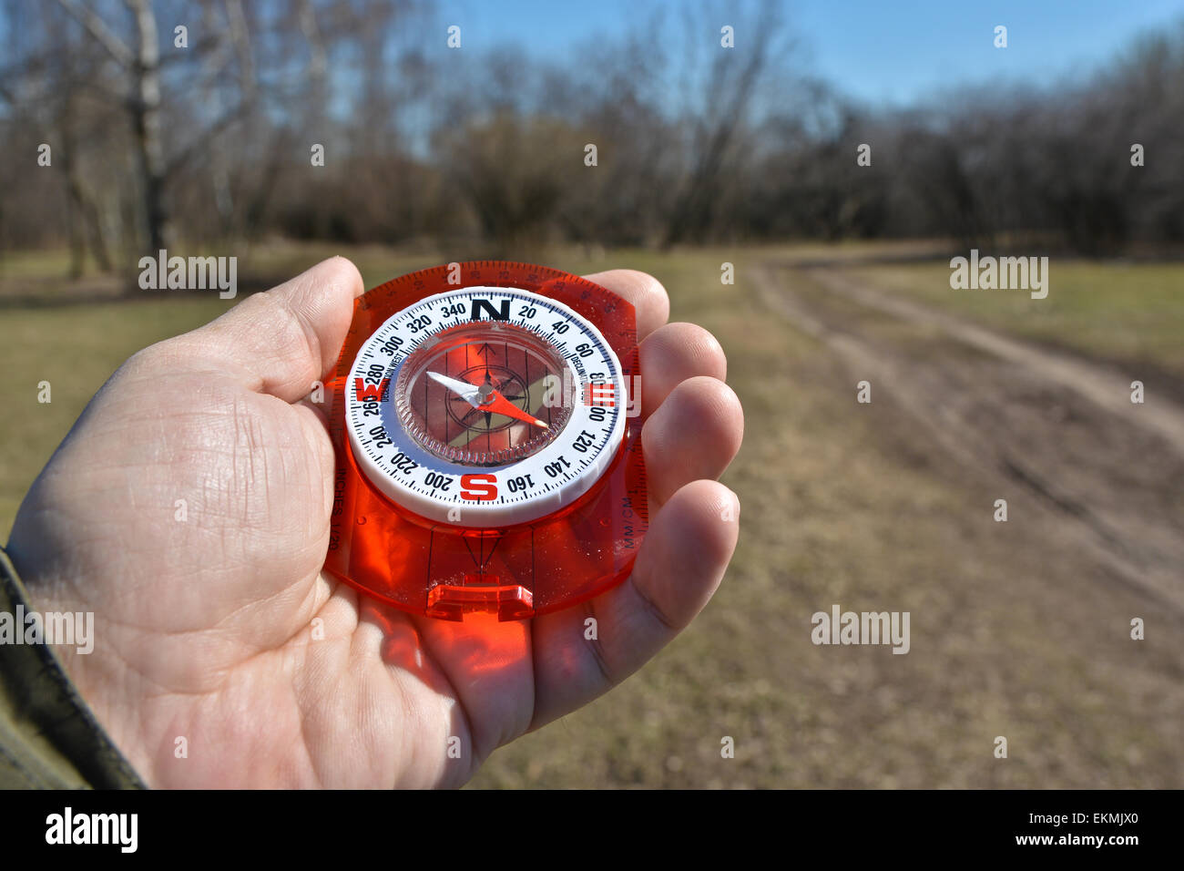 Compass in the hand on a walk. Magnetic compass in the hand on the ...