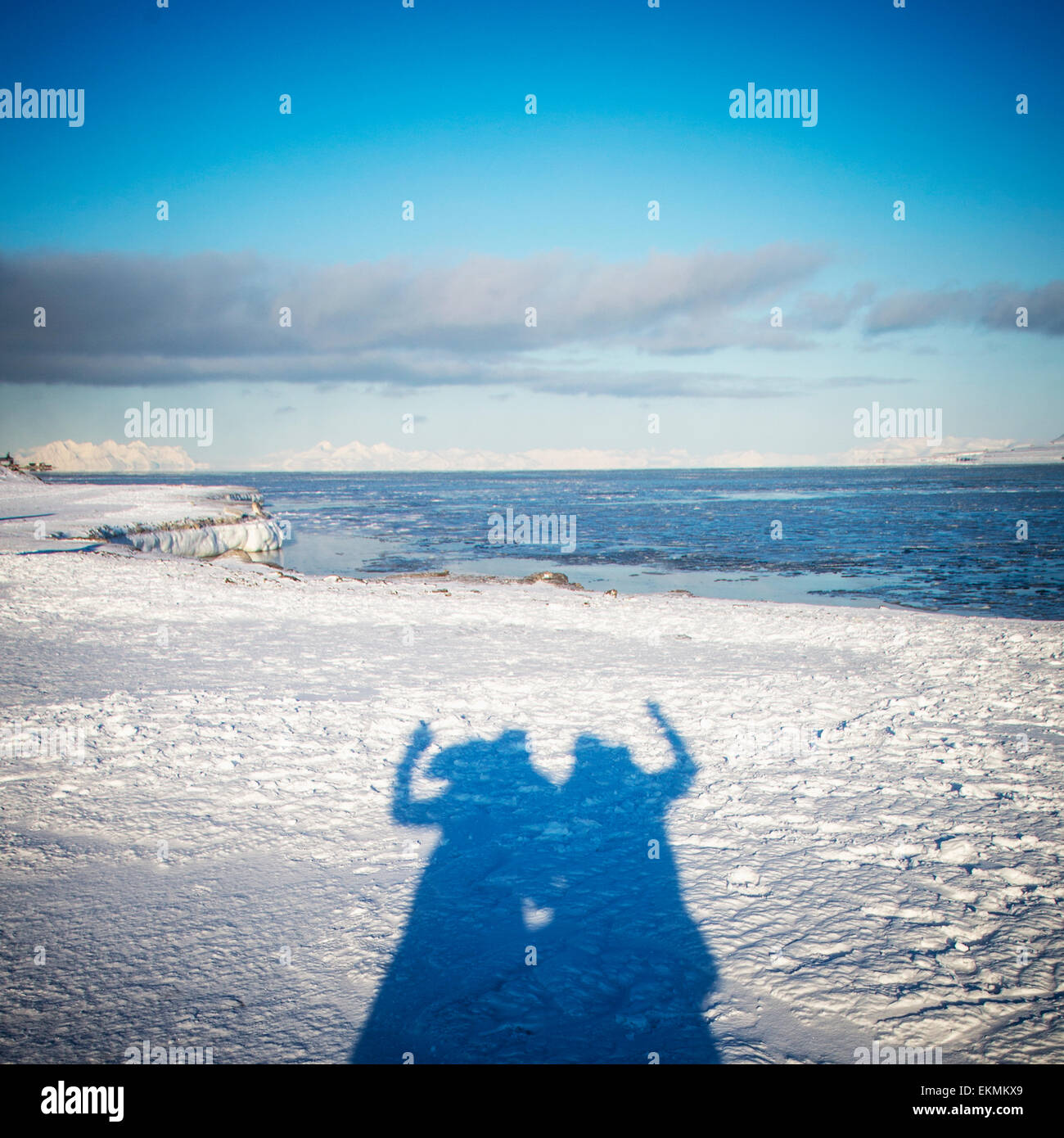 Shadows waving in Svalbard Norway on ice covered surface with ocean ...