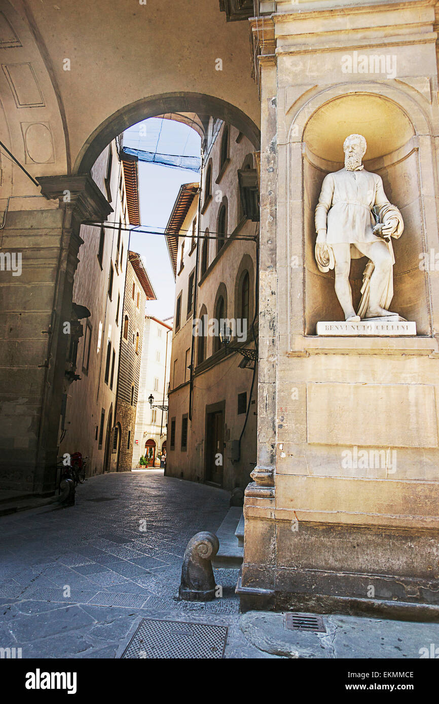 Street with a statue of Benvenuto Cellini in Florence in Italy in ...