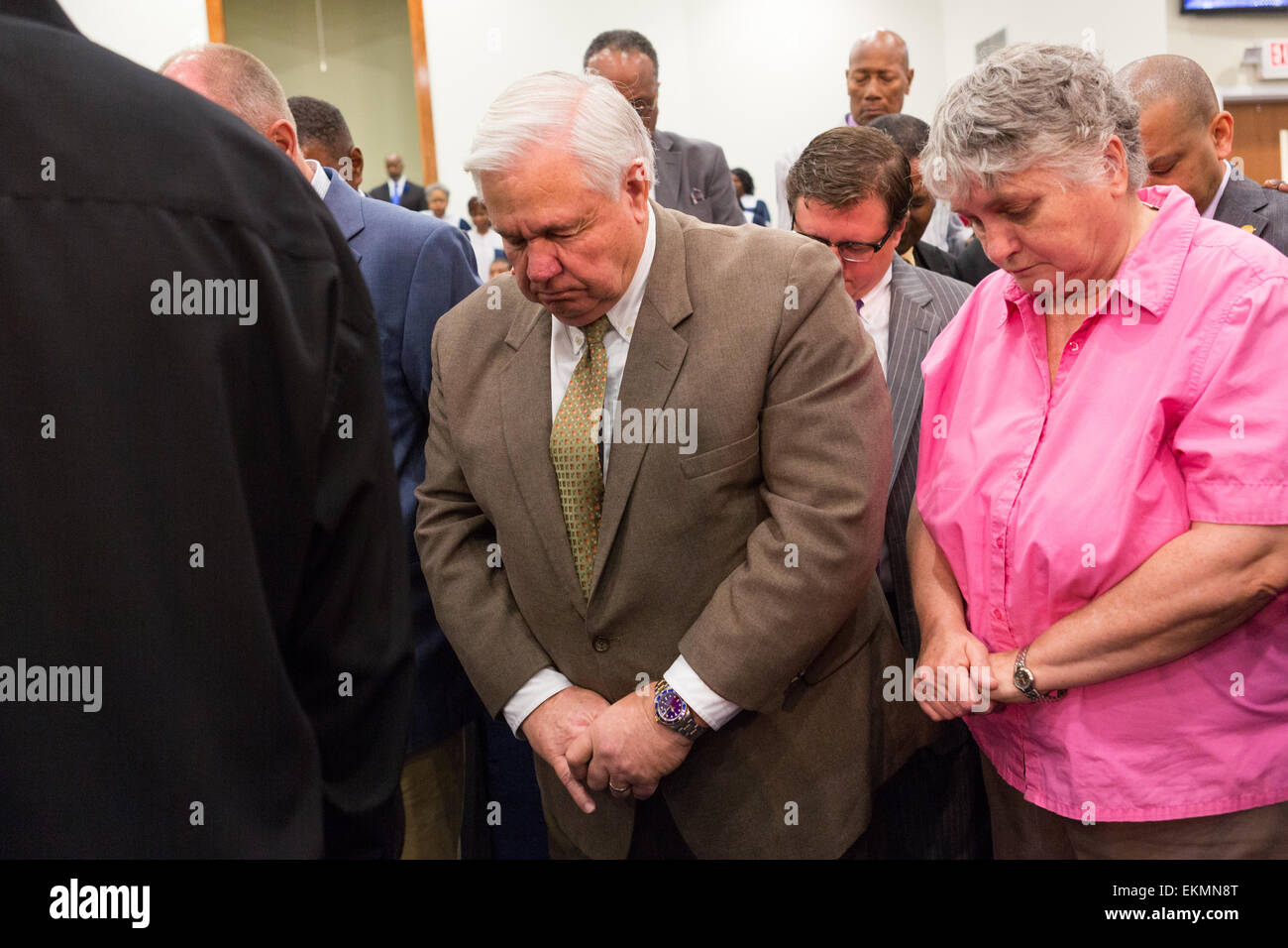 North Charleston Mayor Keith Summey prays with worshippers during a ...