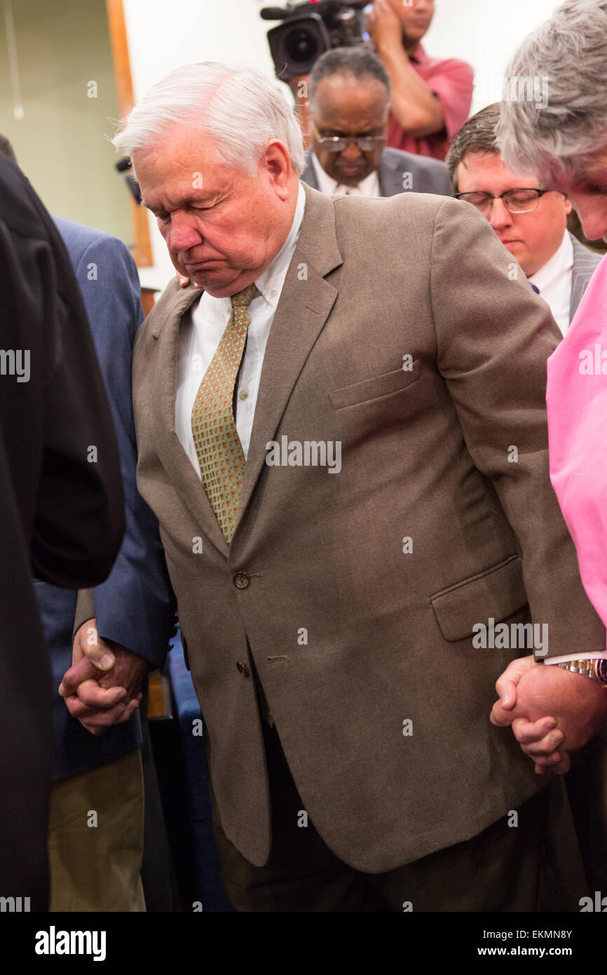 North Charleston Mayor Keith Summey prays with worshippers during a ...