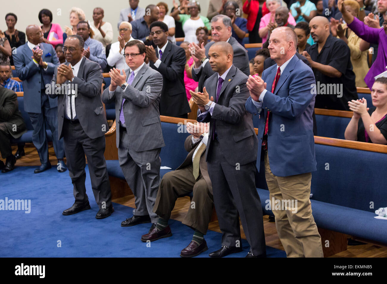 North Charleston Mayor Keith Summey (center) is given a standing ...