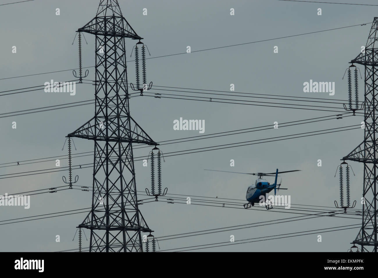 national grid helicopter hovering inspecting power Stock Photo - Alamy