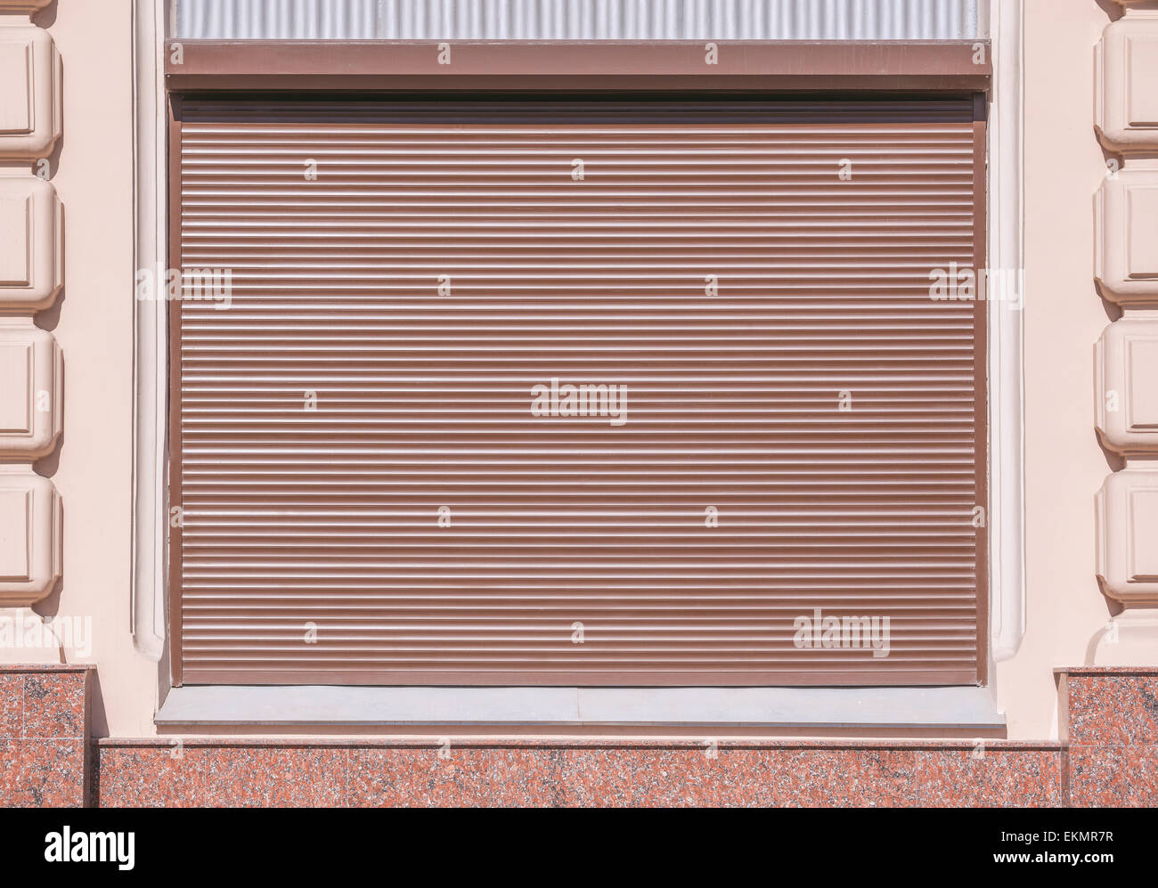 Stone wall with the roller shutter window Stock Photo - Alamy