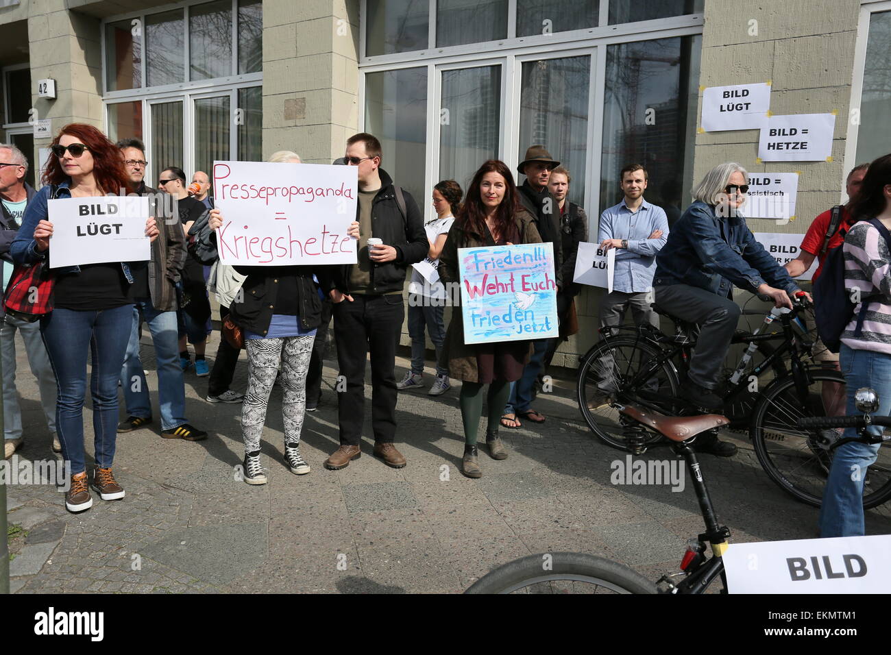 Berlin, Germany. 11th Apr, 2015. Activists hold poster against German ...
