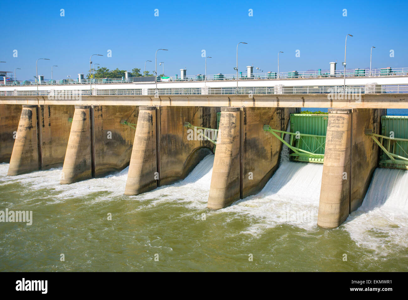 Water rushing through gates at a dam in Kanchanaburi province Stock ...