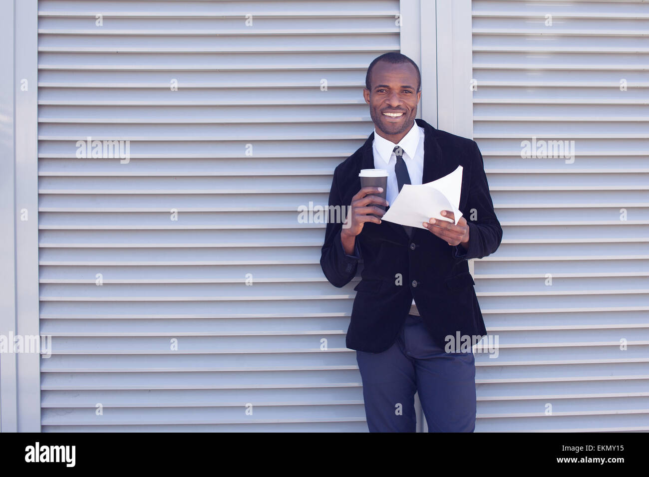 stylish black man documents handling outdoors Stock Photo - Alamy
