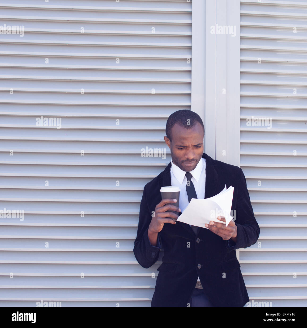 stylish black man documents handling outdoors Stock Photo - Alamy