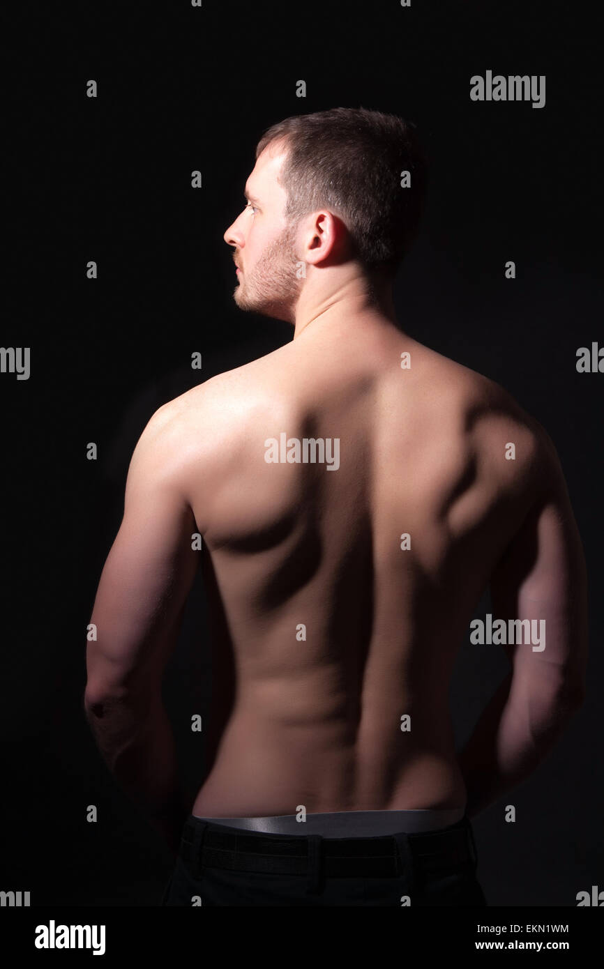 Rear view of a well-built bare-chested young man Stock Photo - Alamy