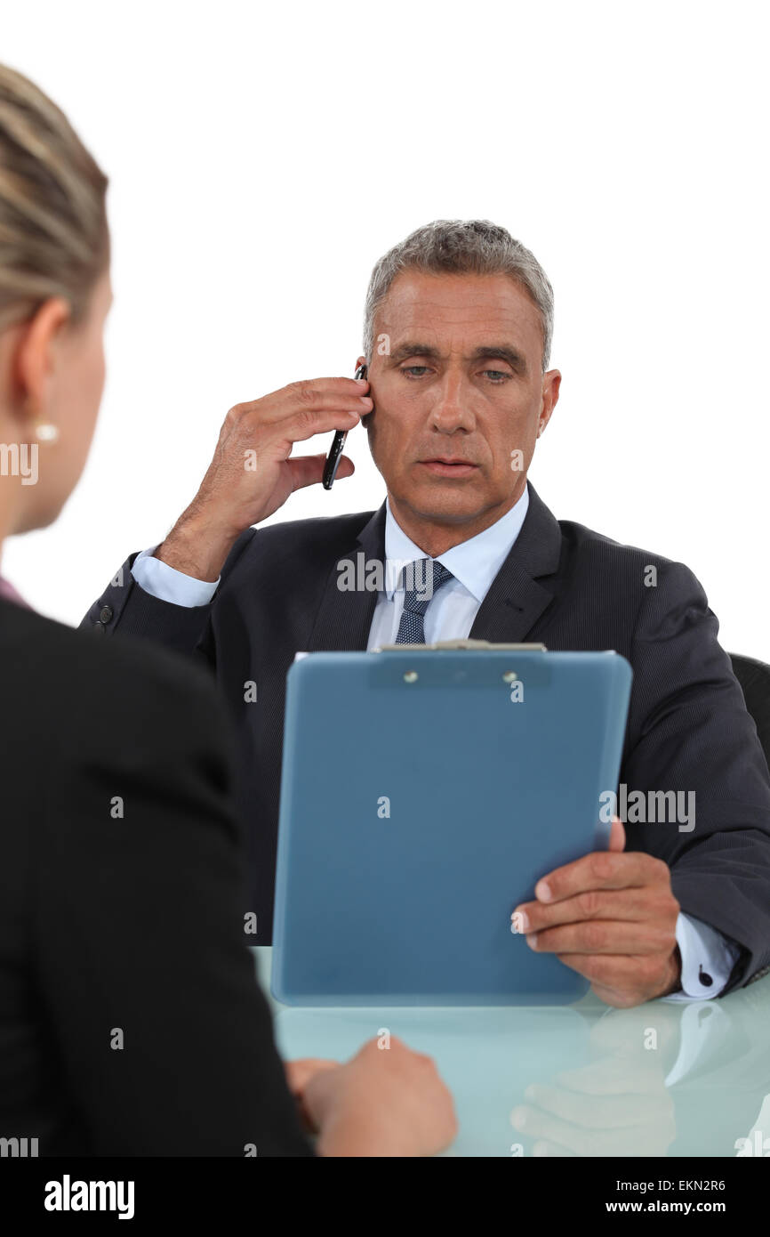 Boss checking colleague's work Stock Photo - Alamy