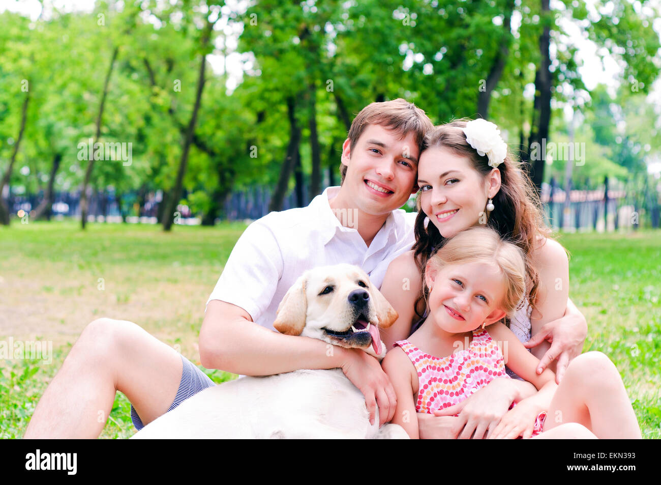 Happy young family with Labrador Stock Photo - Alamy